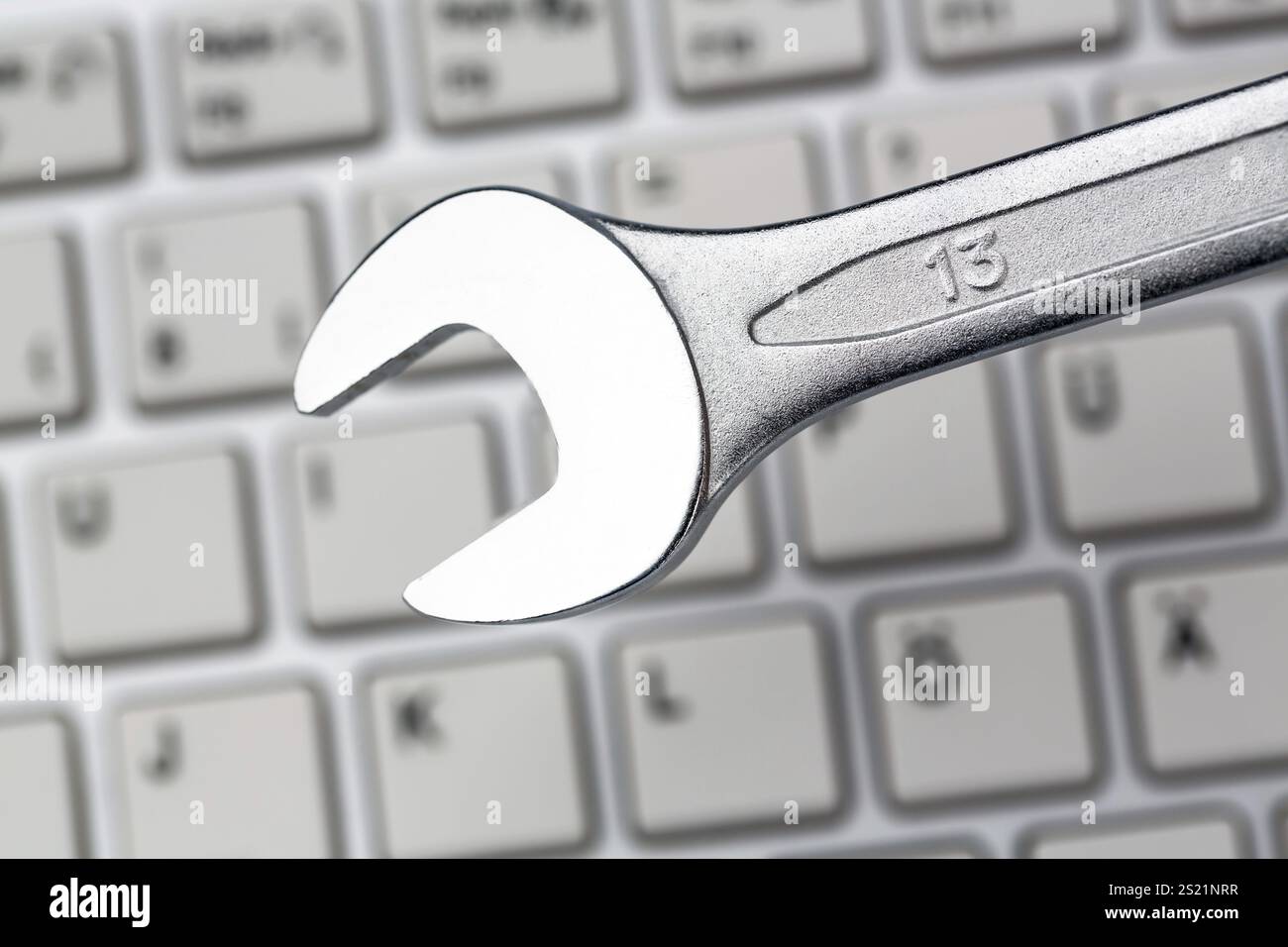 A spanner as a tool on a computer keyboard. Symbolic photo for data ...