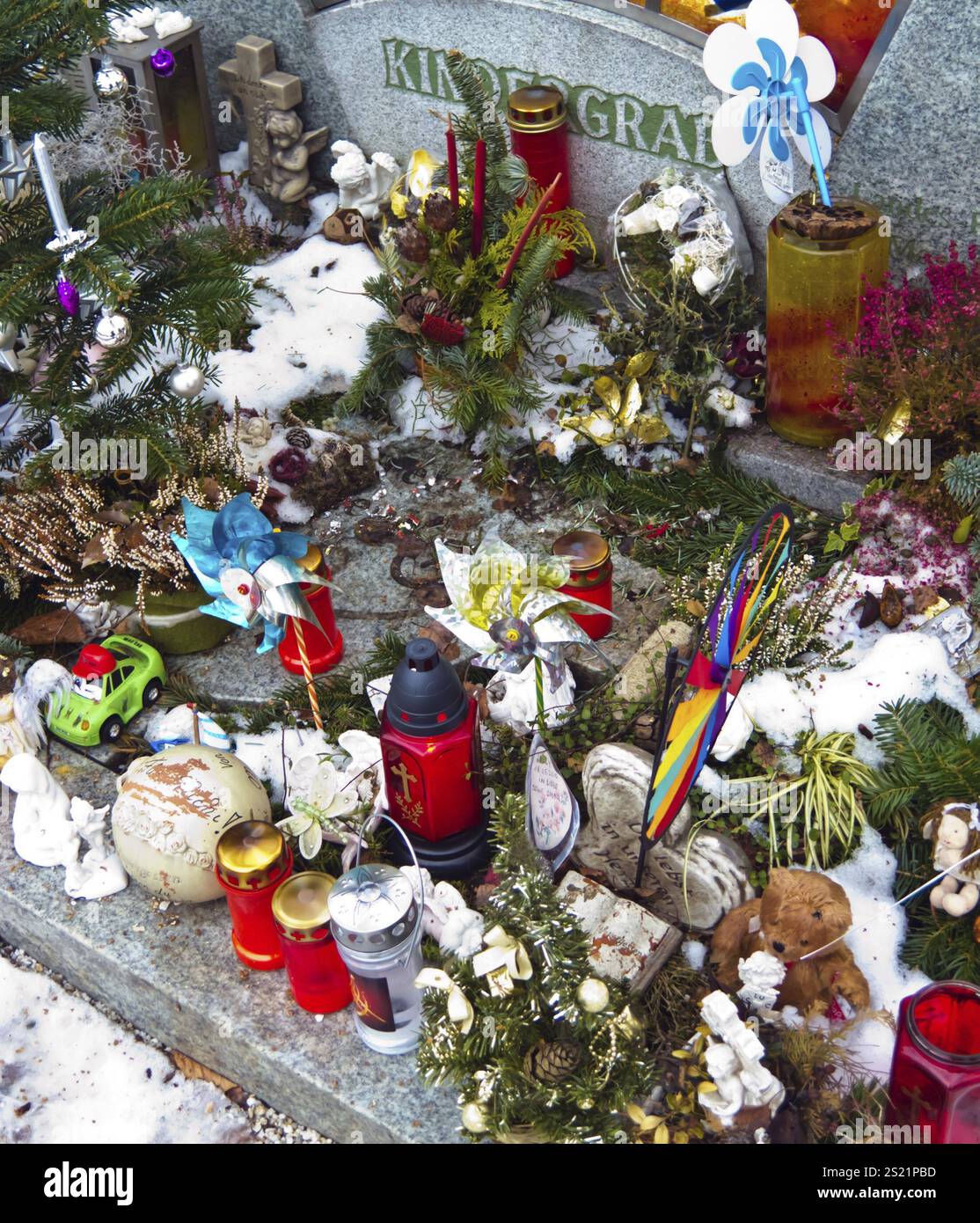 Toys Objects and candles on the grave of a child Austria Stock Photo ...