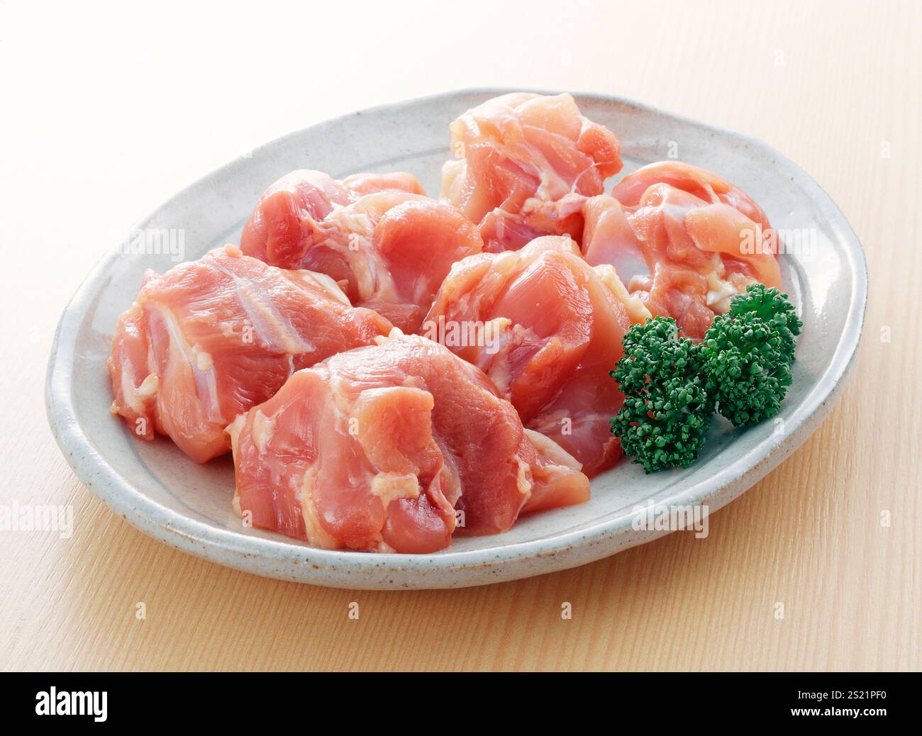 Chicken thighs, cut into cubes Stock Photo - Alamy