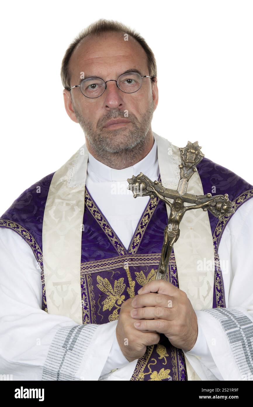 A catholic priest with a cross in front of a white background Austria ...