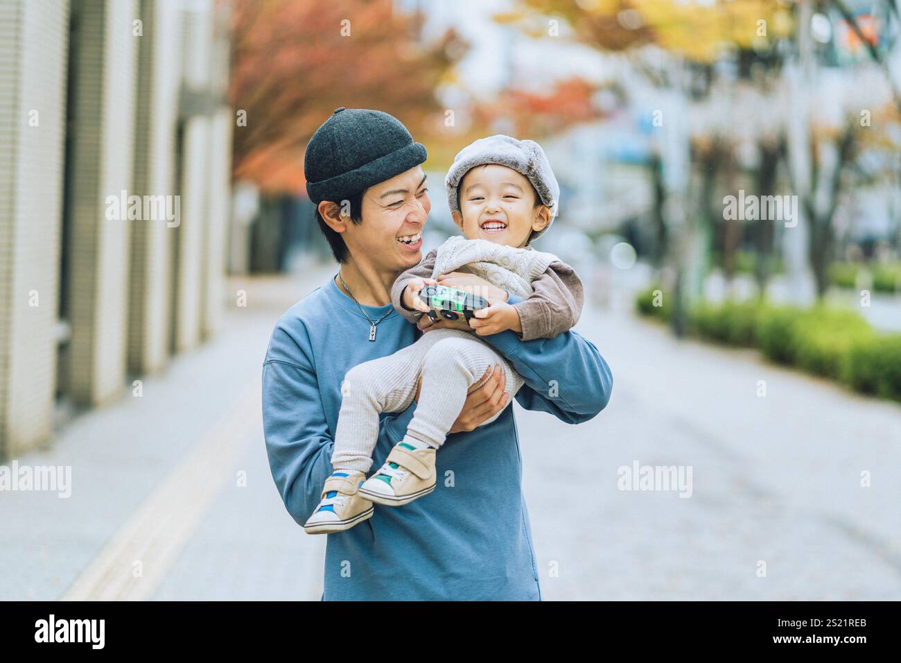 Parents and children happily playing outdoors Stock Photo - Alamy