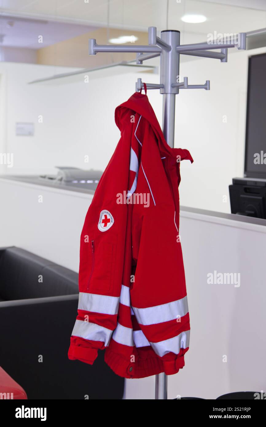 The jacket of a Red Cross employee hangs in a wardrobe. Austria Stock ...