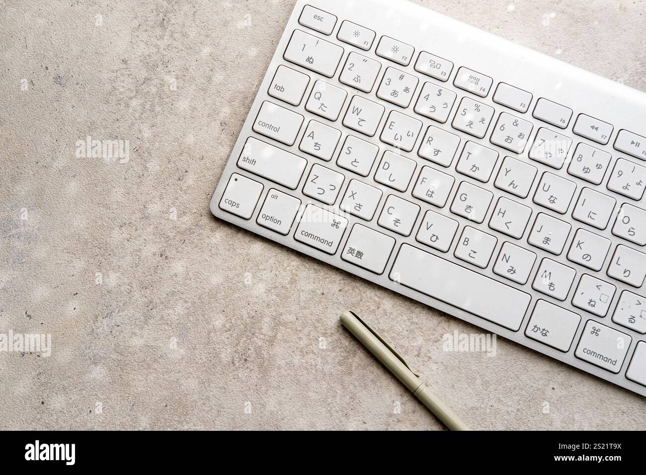 Keyboard, pen and pen on grey table Stock Photo - Alamy