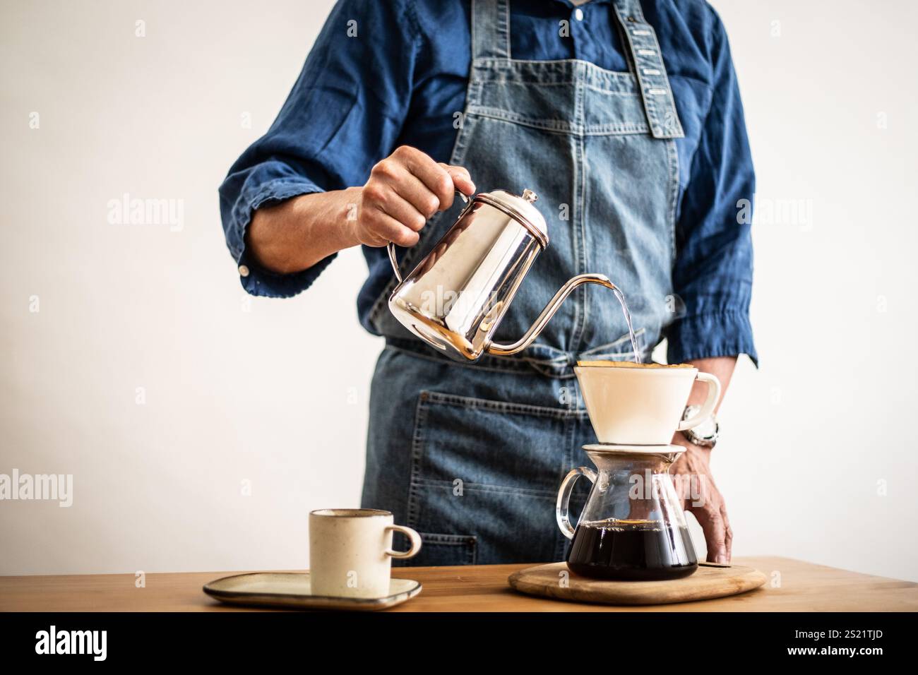 Black man roasting coffee hi-res stock photography and images - Alamy