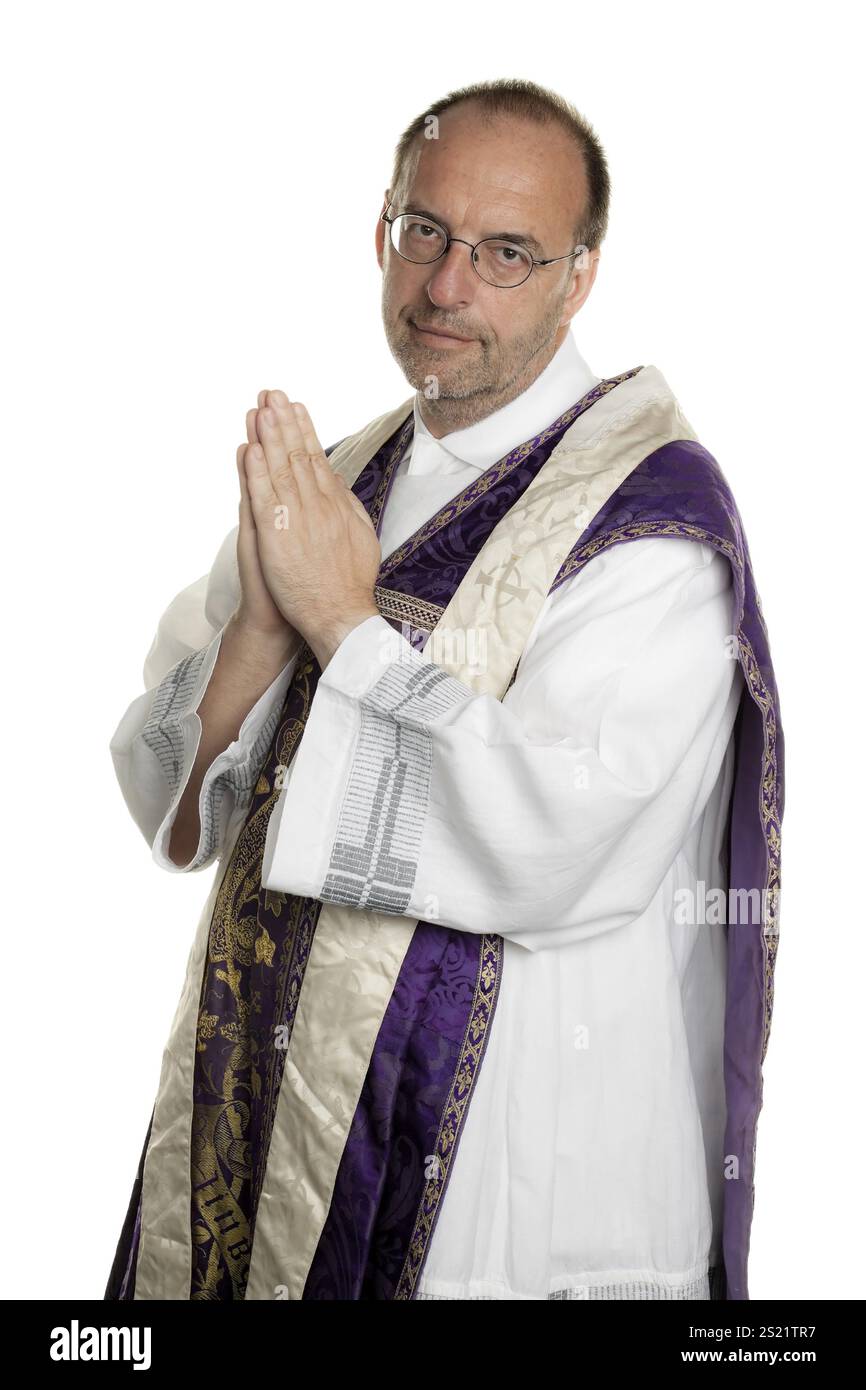 A Catholic priest praying during a church service Austria Stock Photo ...