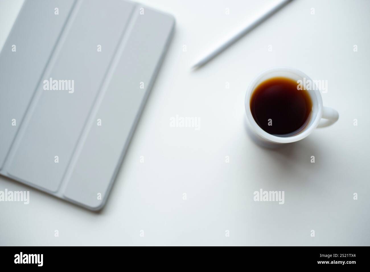 Simple photo for remote working, coffee and tablet Stock Photo - Alamy