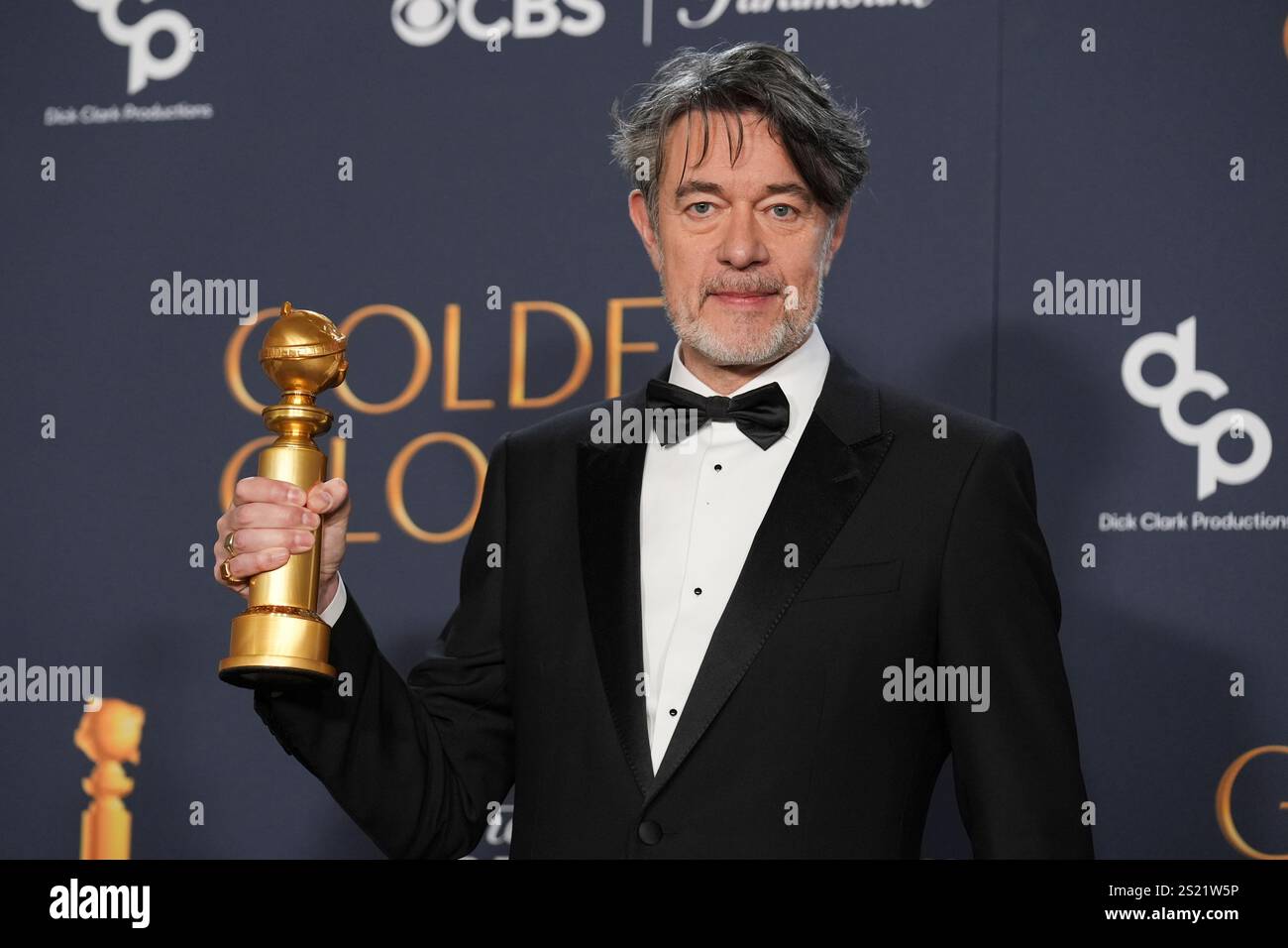 Peter Straughan poses in the press room with the award for best ...