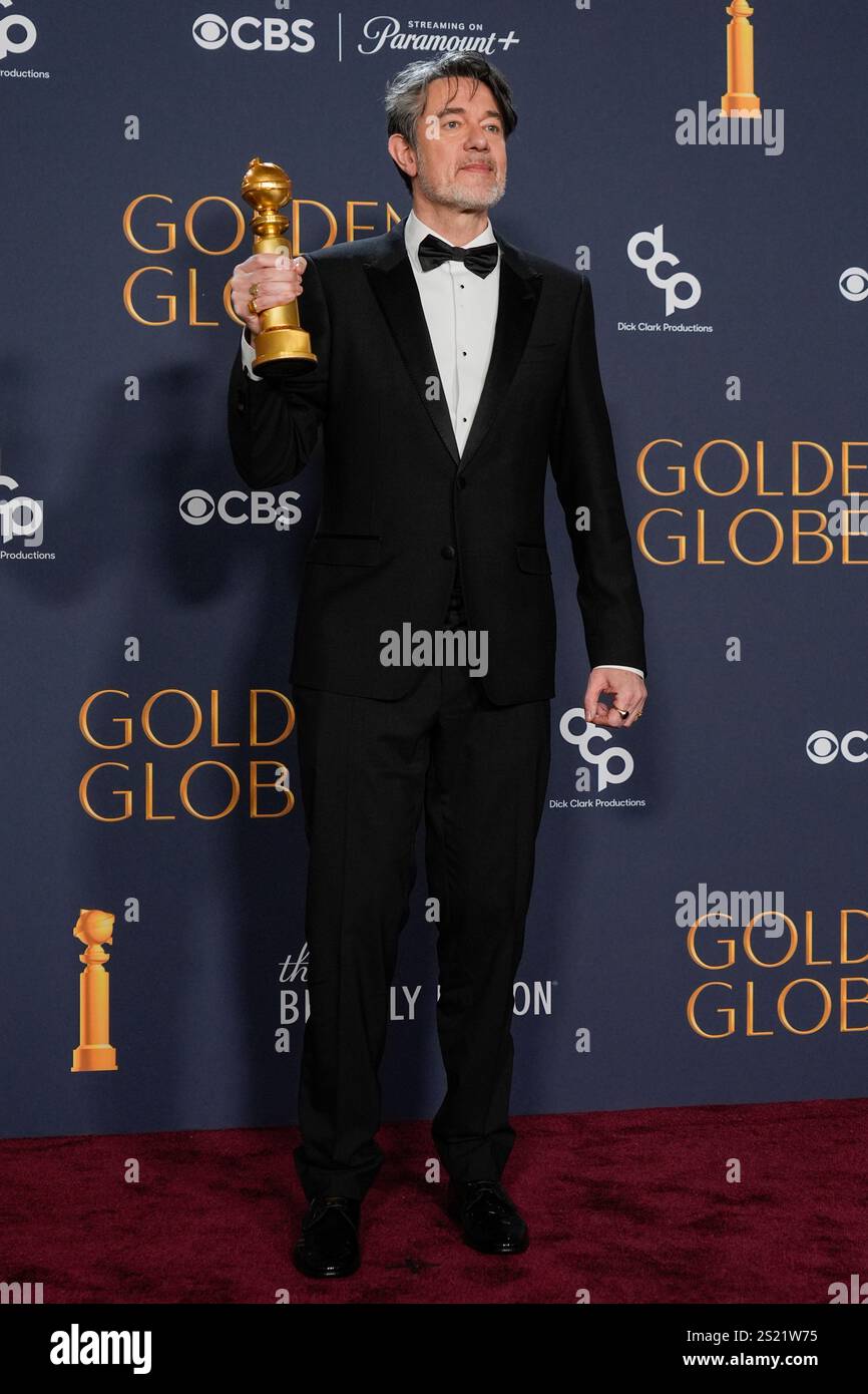 Peter Straughan poses in the press room with the award for best ...