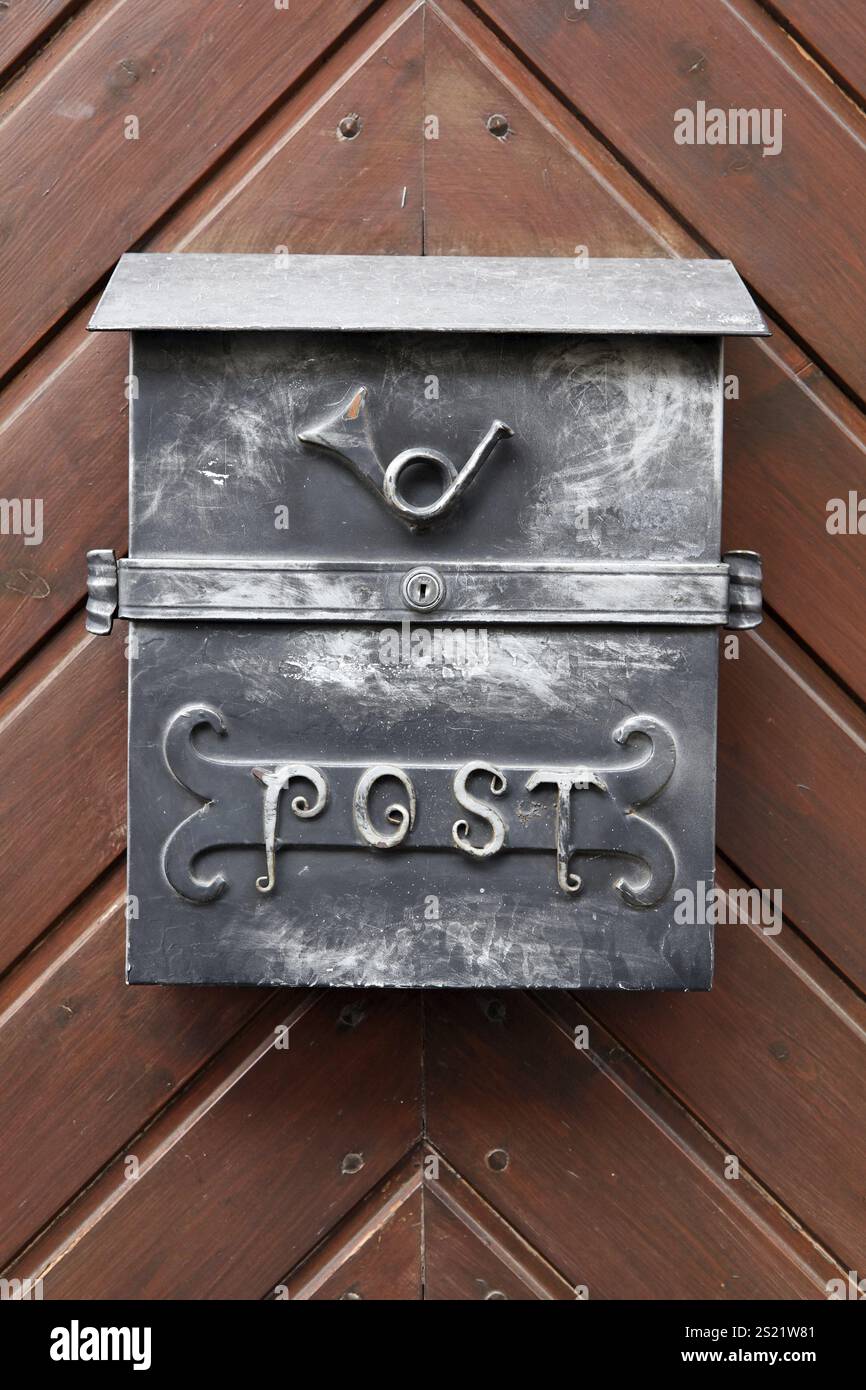 Rustic iron letterbox on a wooden entrance door Stock Photo - Alamy