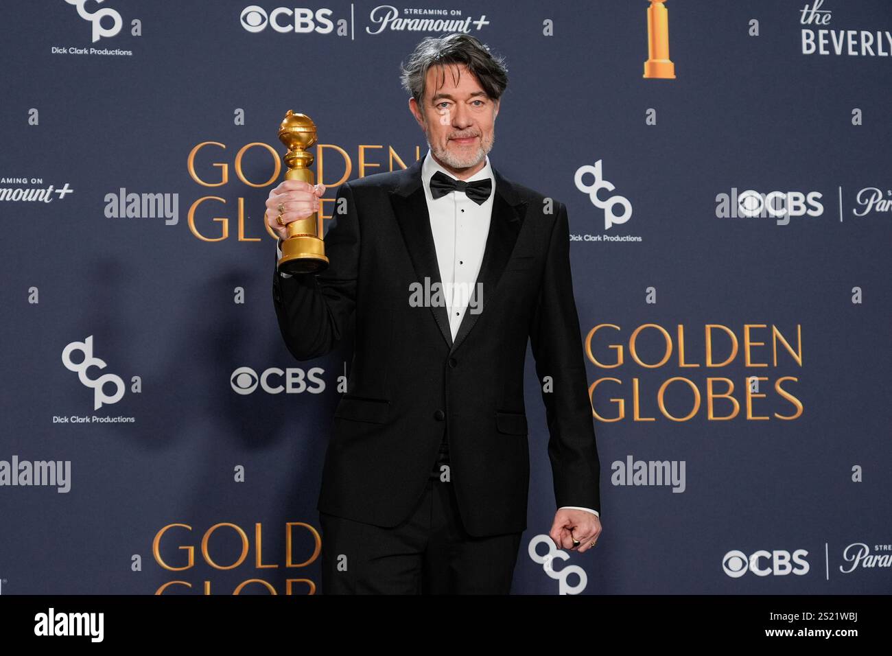 Peter Straughan poses in the press room with the award for best ...