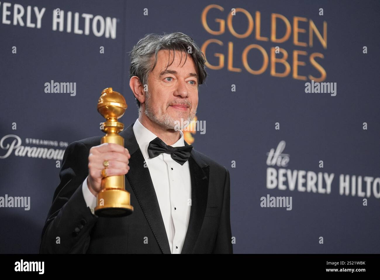 Peter Straughan poses in the press room with the award for best ...