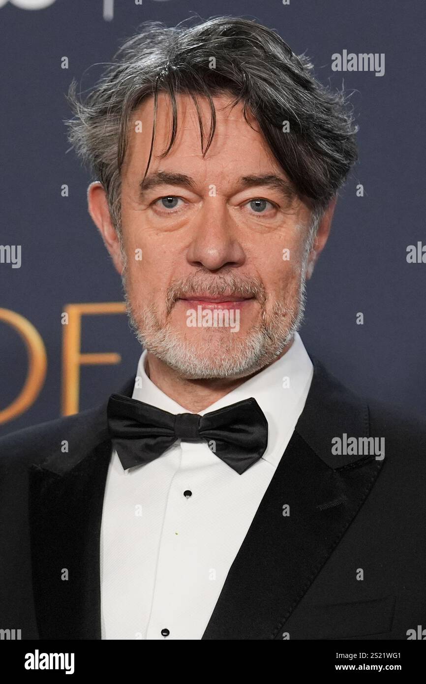 Peter Straughan poses in the press room with the award for best ...