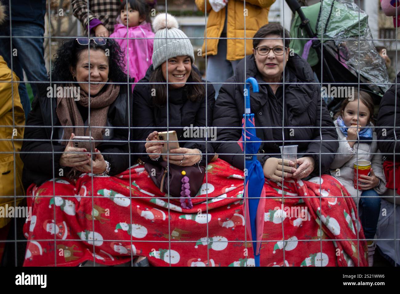 Madrid, Spain. 05th Jan, 2025. A group awaits the passage of the Three ...