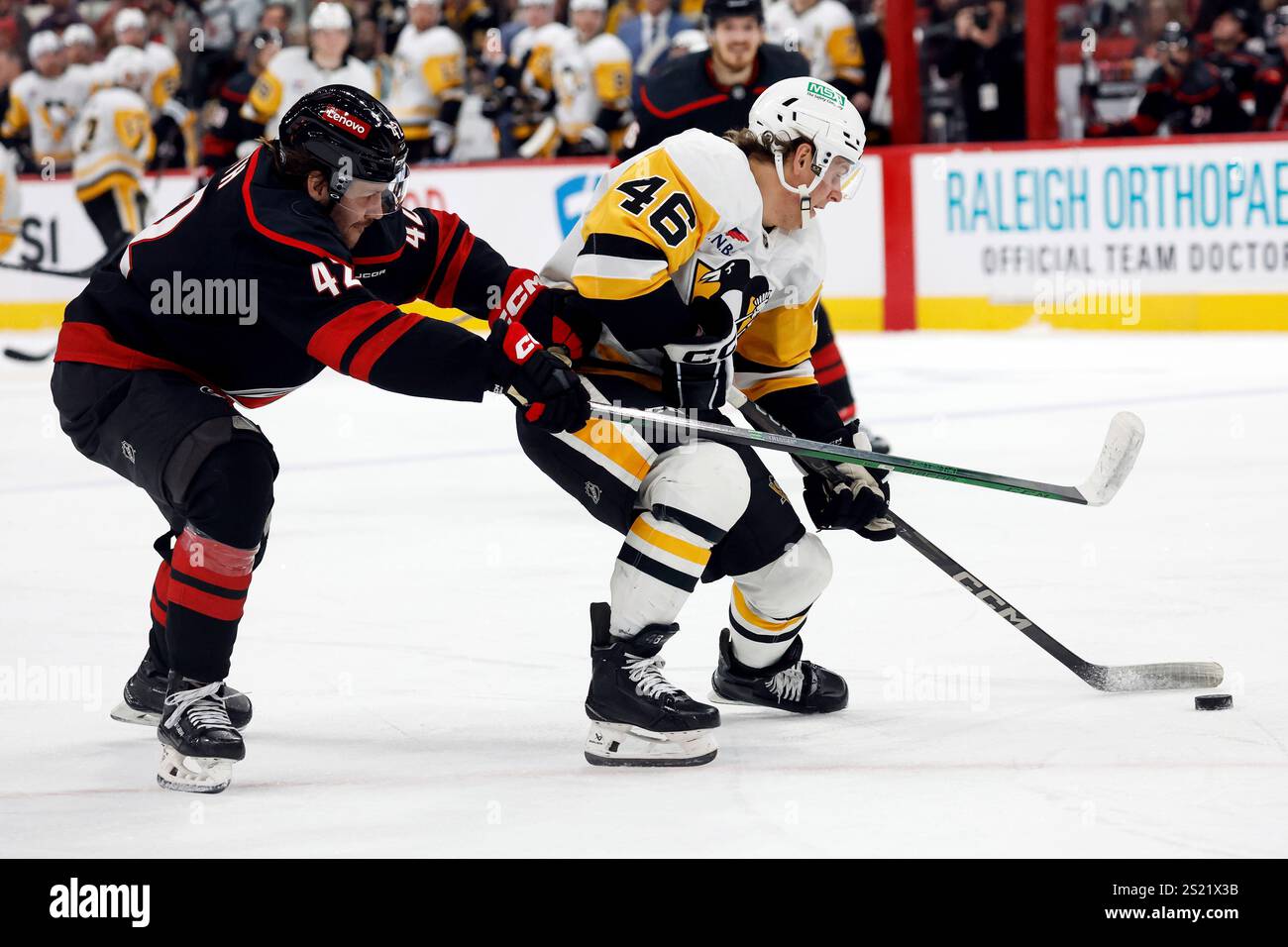 Carolina Hurricanes' Ty Smith (42) pressures Pittsburgh Penguins' Blake ...