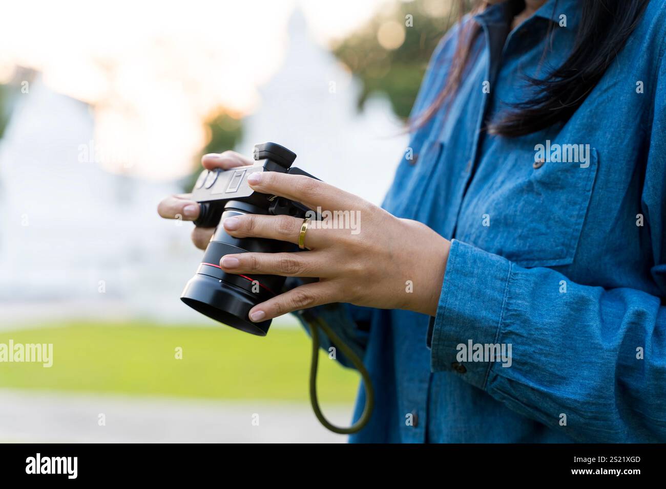 Senior woman using camera and looking at photos in nature. Finger ...