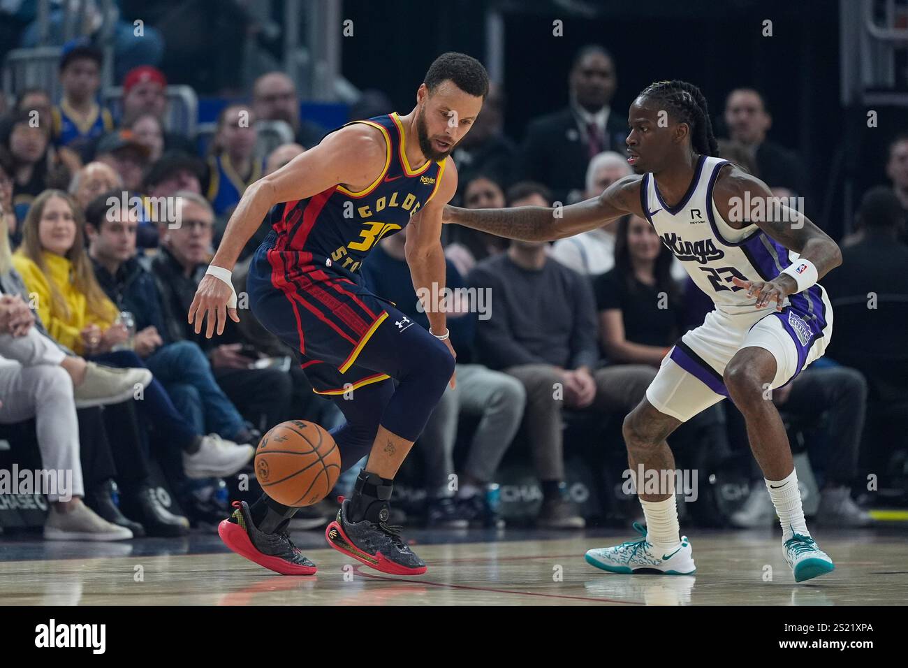 Golden State Warriors guard Stephen Curry, left, moves the ball while ...