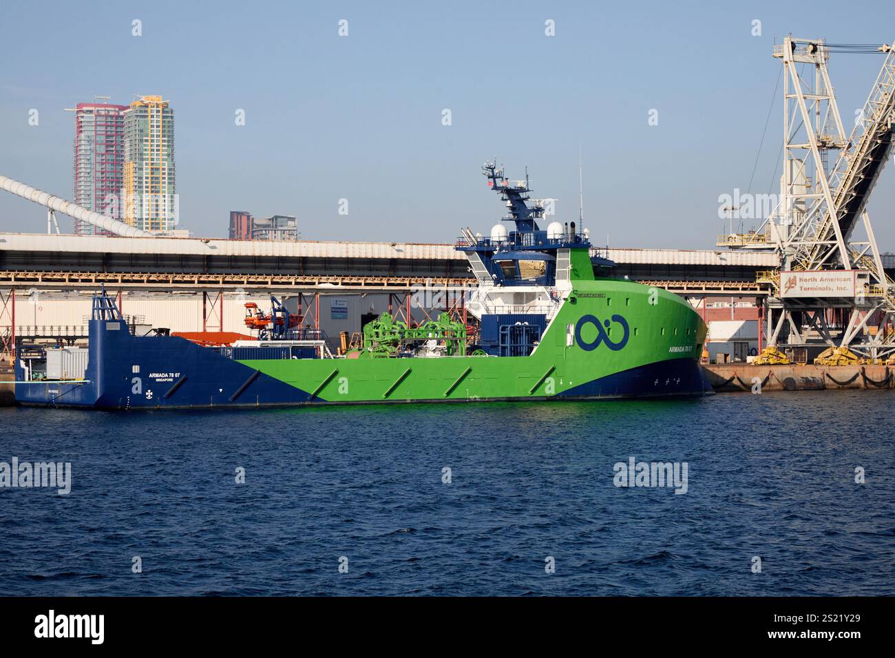 San Diego, California, USA. 21st Dec, 2024. The striking green and blue Armada 701 vessel docked ...
