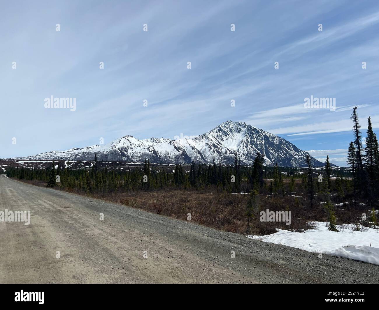 Mountain with snow next to a dirt road along the Denali Highway on a ...