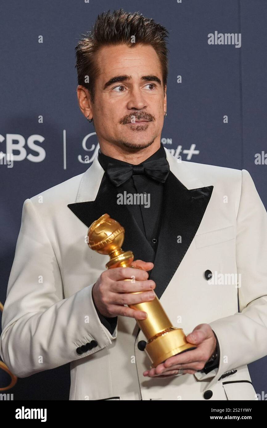 Colin Farrell poses in the press room with the award for best ...