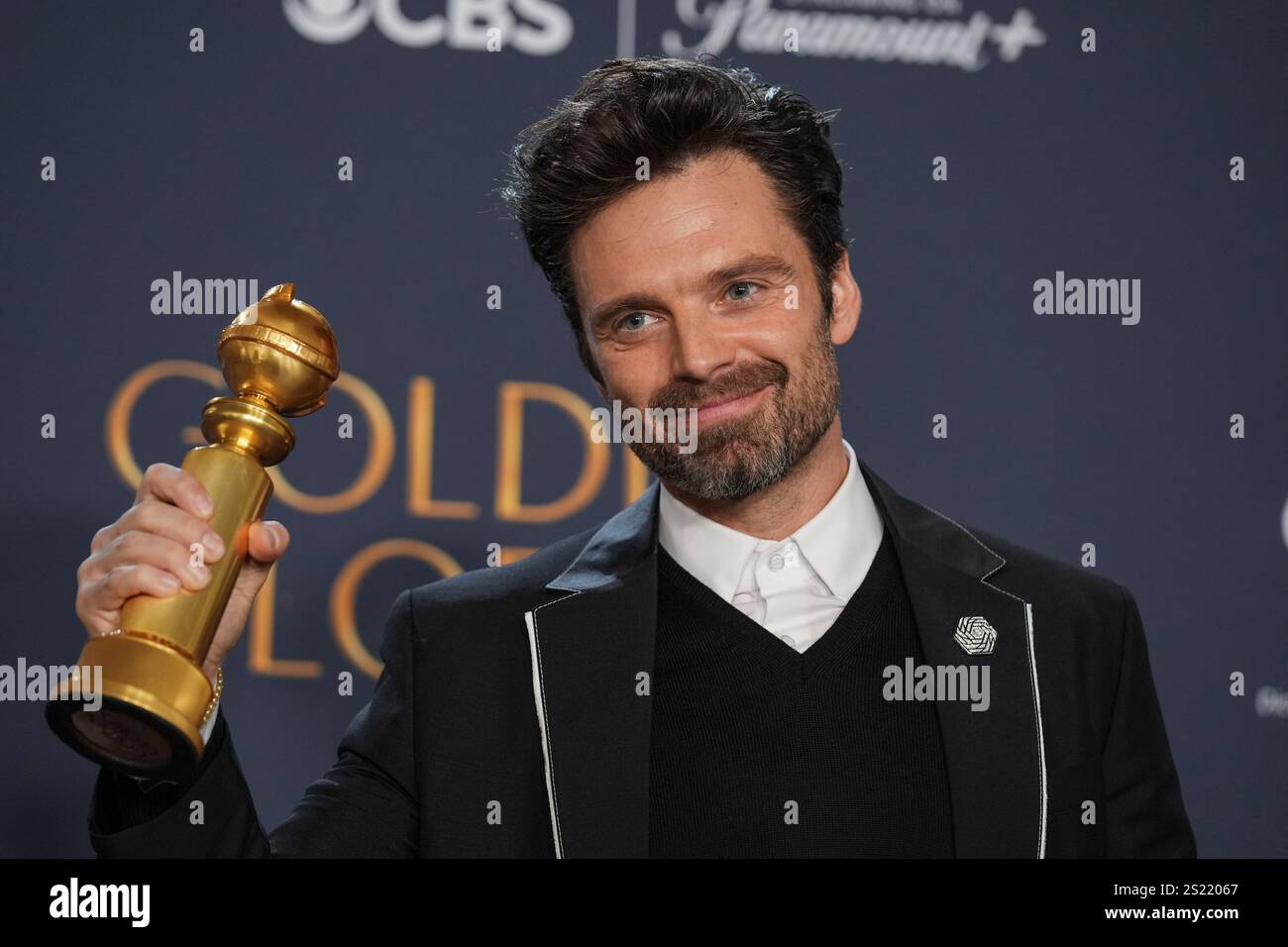 Sebastian Stan poses in the press room with the award for best ...