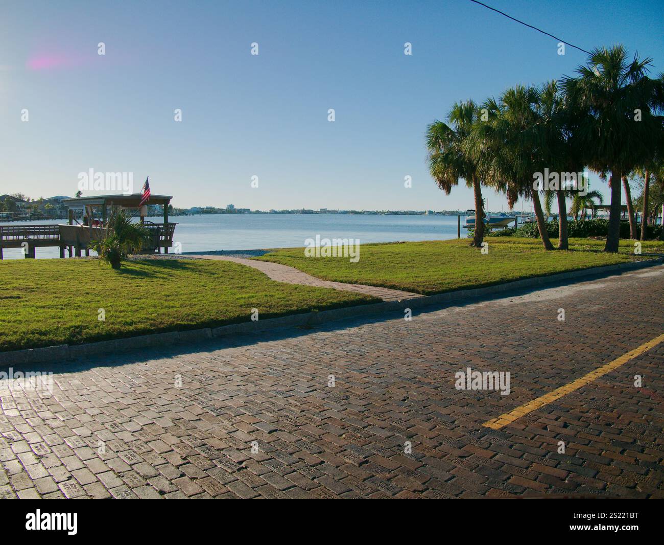 View across old brick street and green grass to leading lines of ...