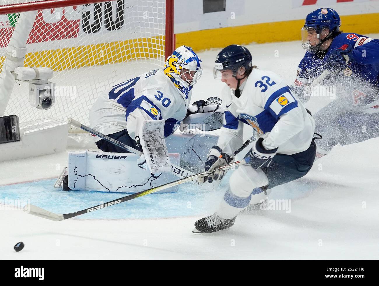 Finland goaltender Petteri Rimpinen (30) looks on as teammate Emil ...