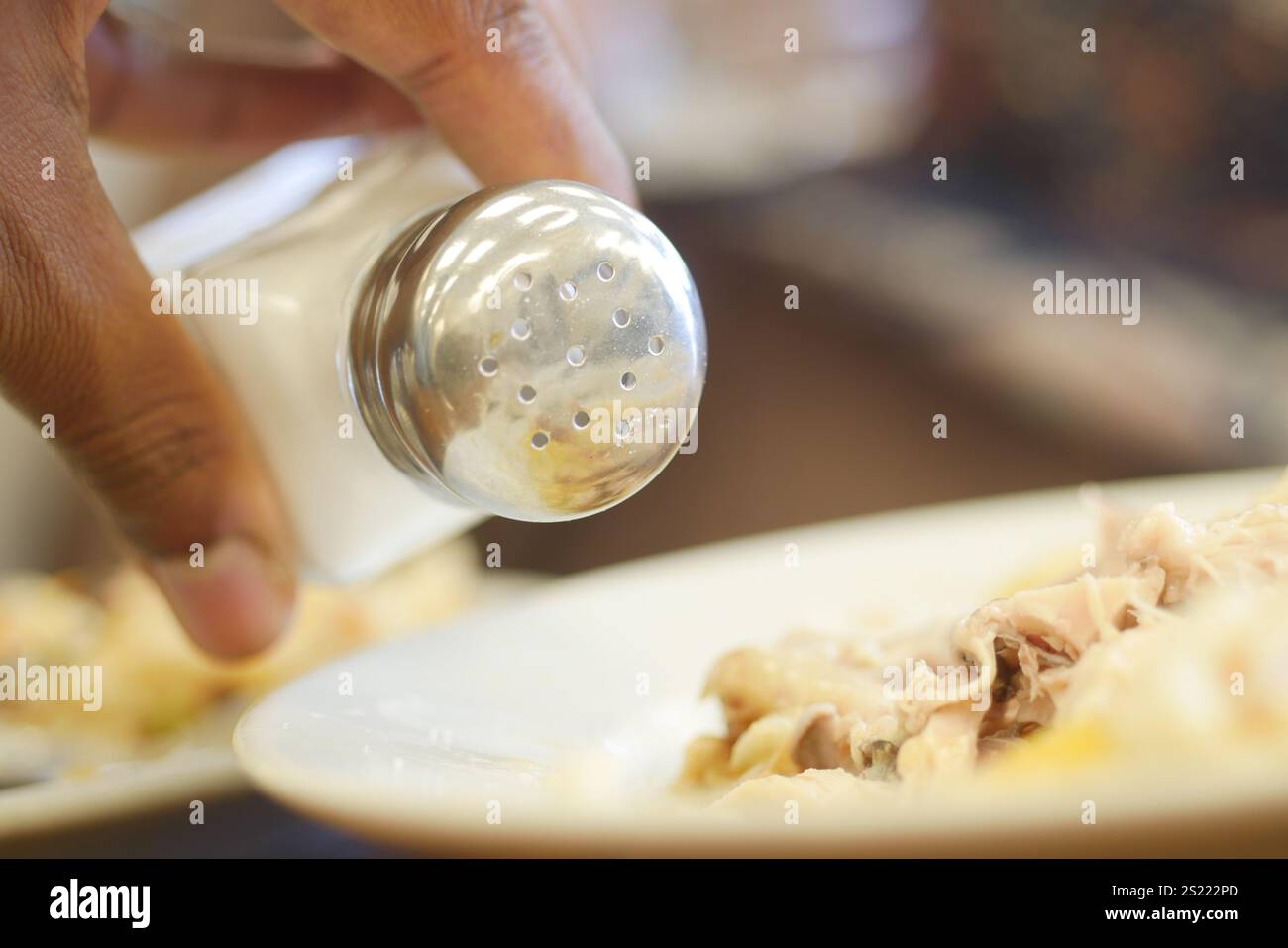 Salt falls from a salt shaker Stock Photo - Alamy