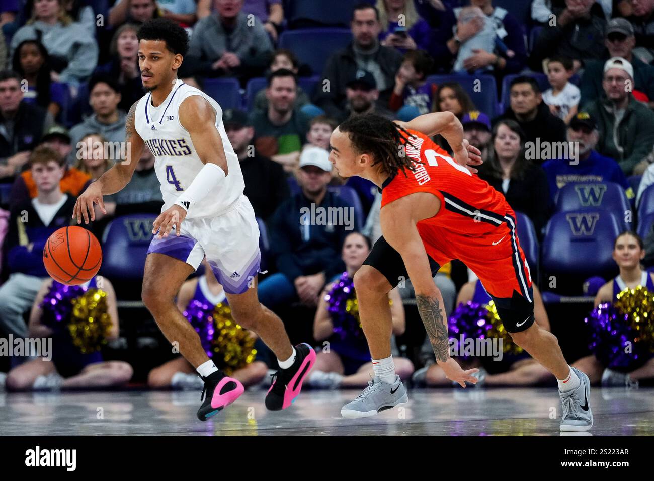 Washington guard DJ Davis moves the ball against Illinois guard Dra ...
