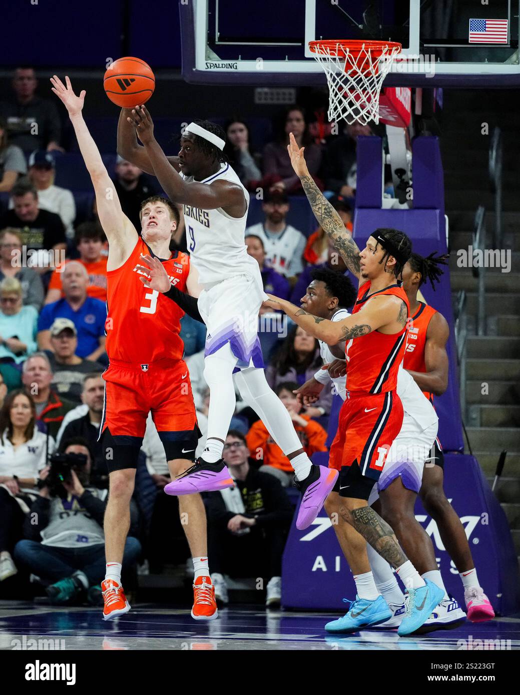 Washington guard Vazoumana Diallo passes the ball against the defense ...