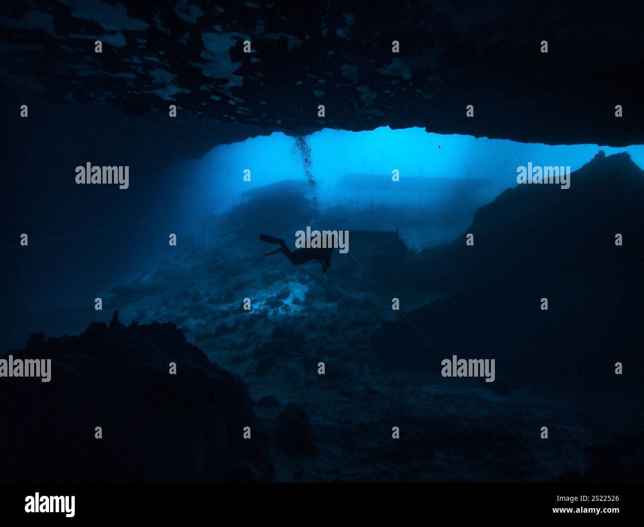 Sunlight illuminating the underwater cavern entrance in the sinkhole at ...