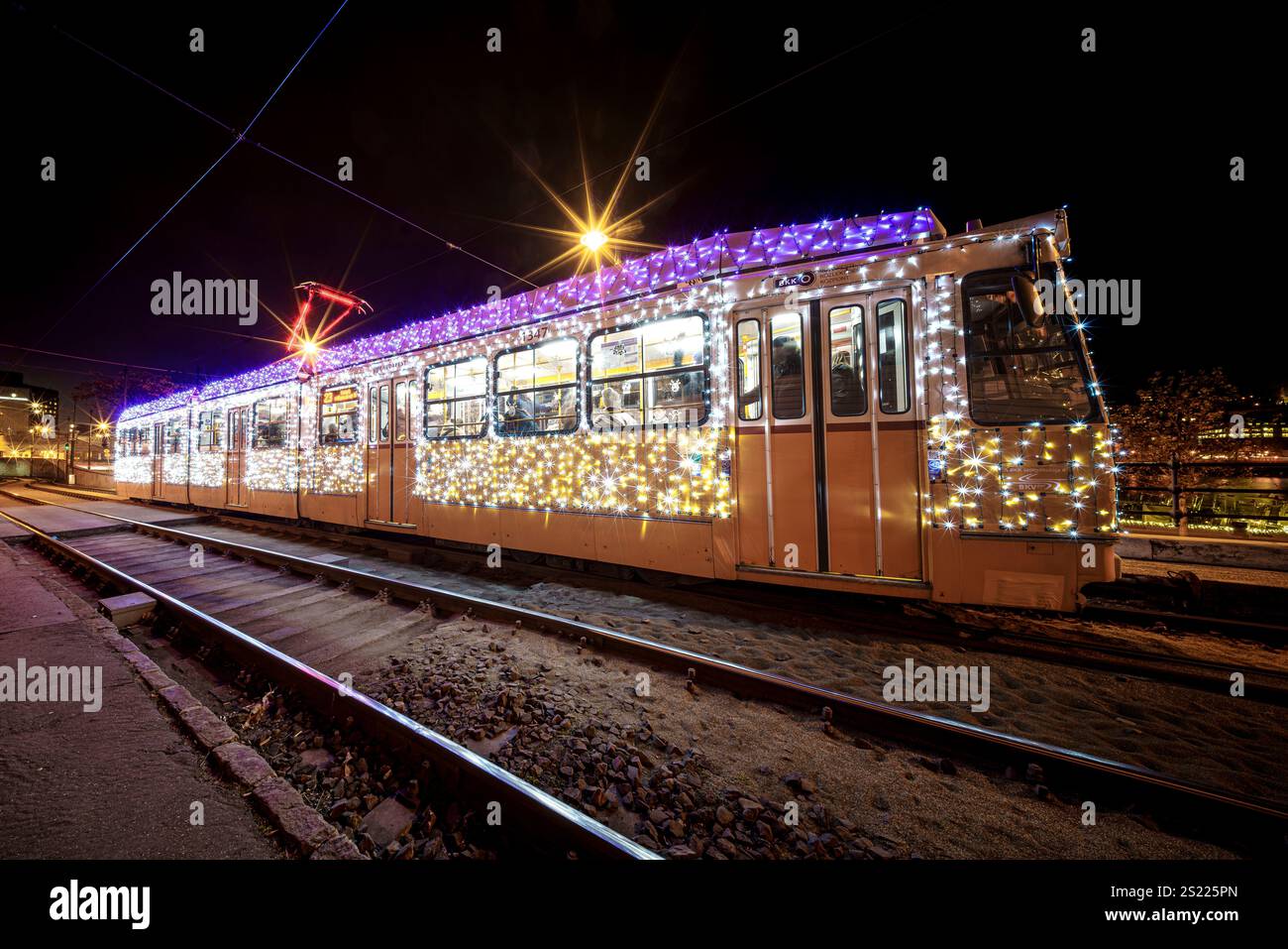 Festively decorated light tram (fenyvillamos) in streets of Budapest ...
