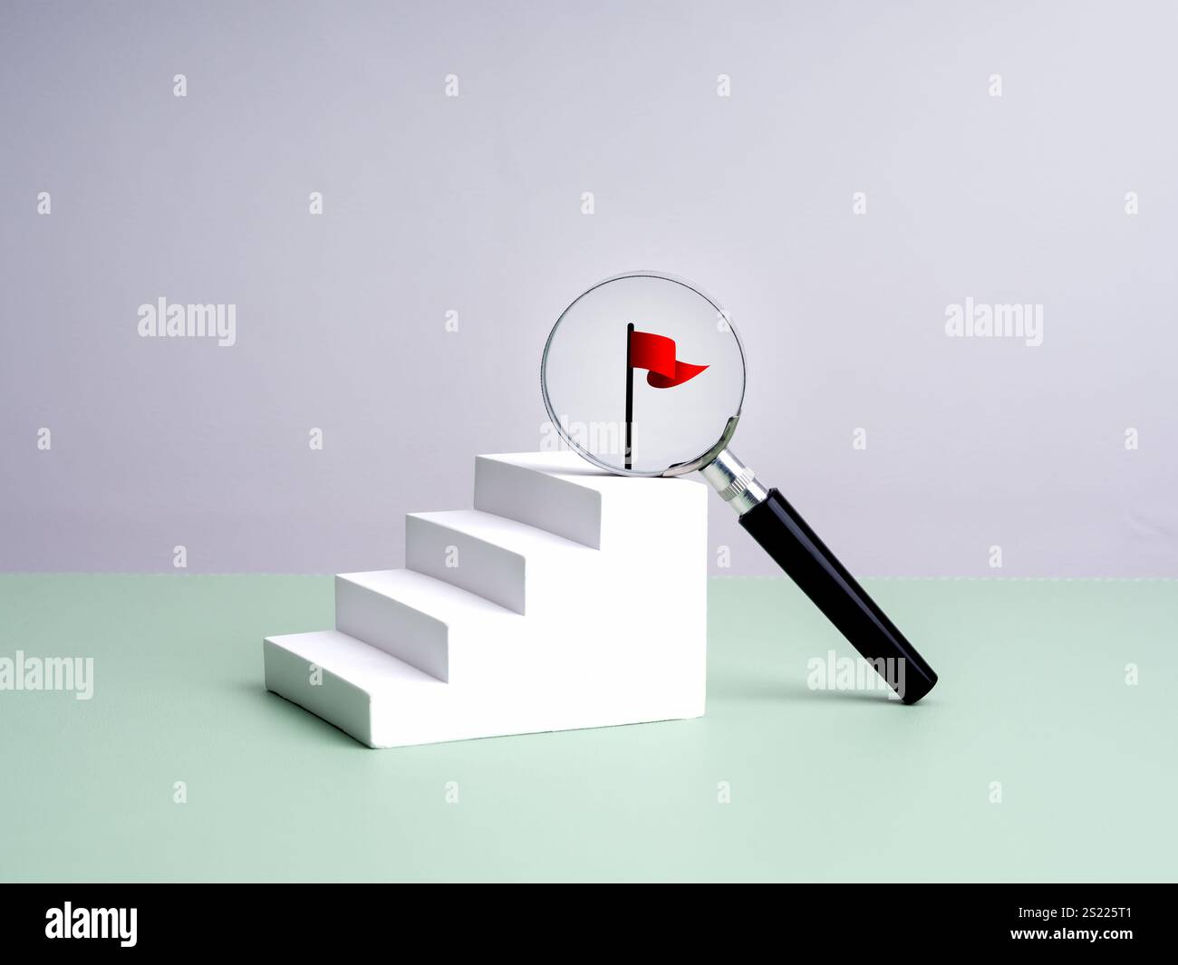 Red winner flag focused by magnifying glass, on top of white geometric ...