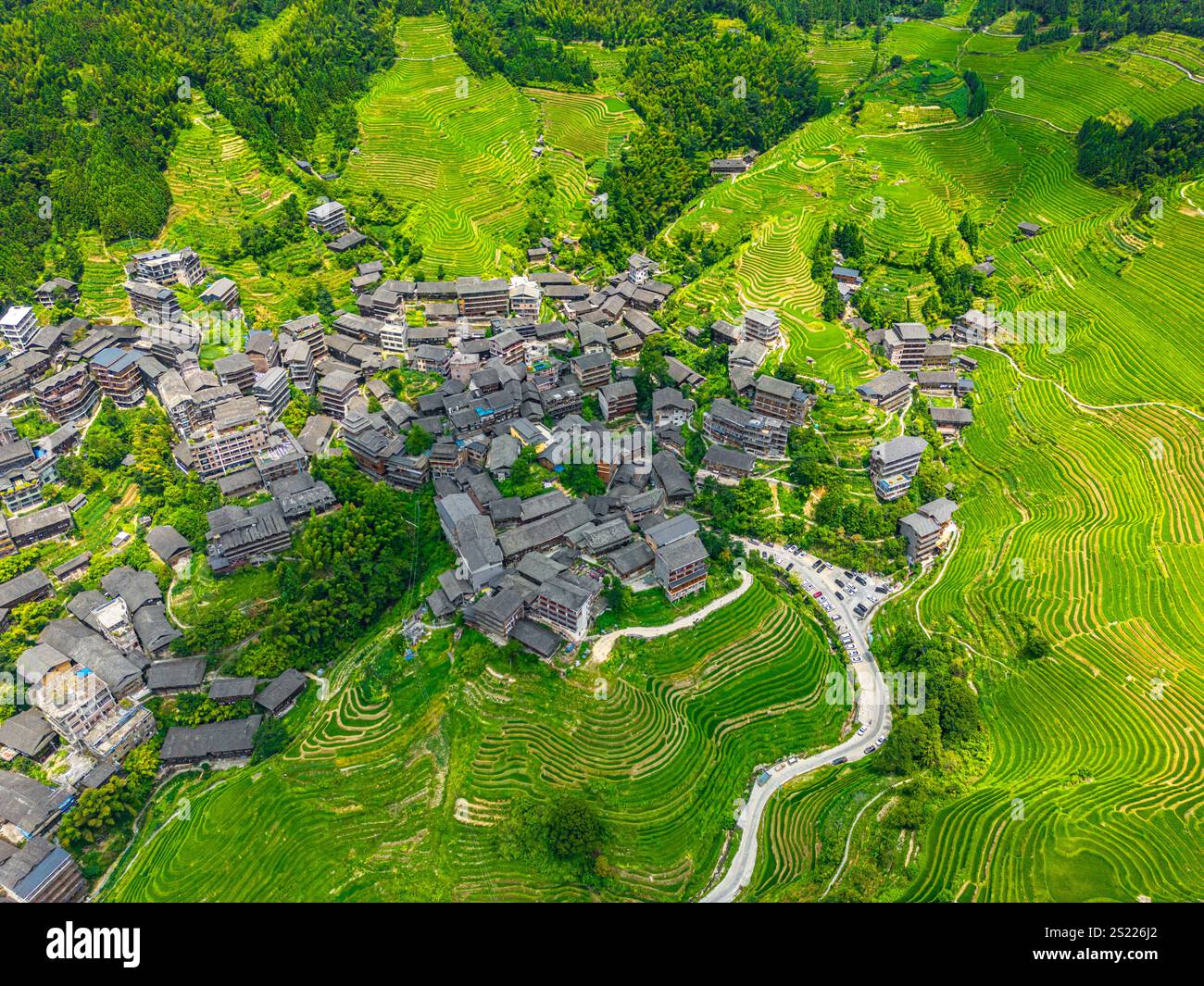 The wooden houses of the village surrounded by Longji rice terraces ...
