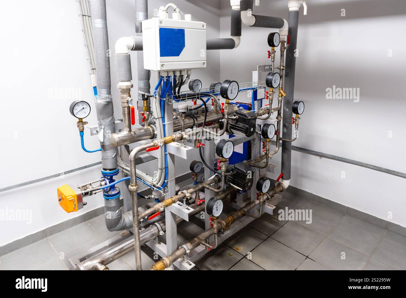 Complex piping system with pressure gauges in a modern industrial ...