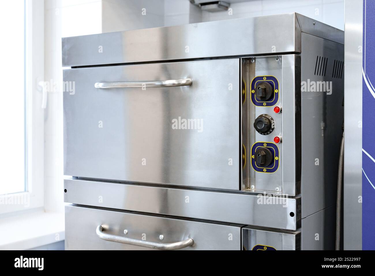 Modern stainless steel oven in a bright, contemporary kitchen with dual ...