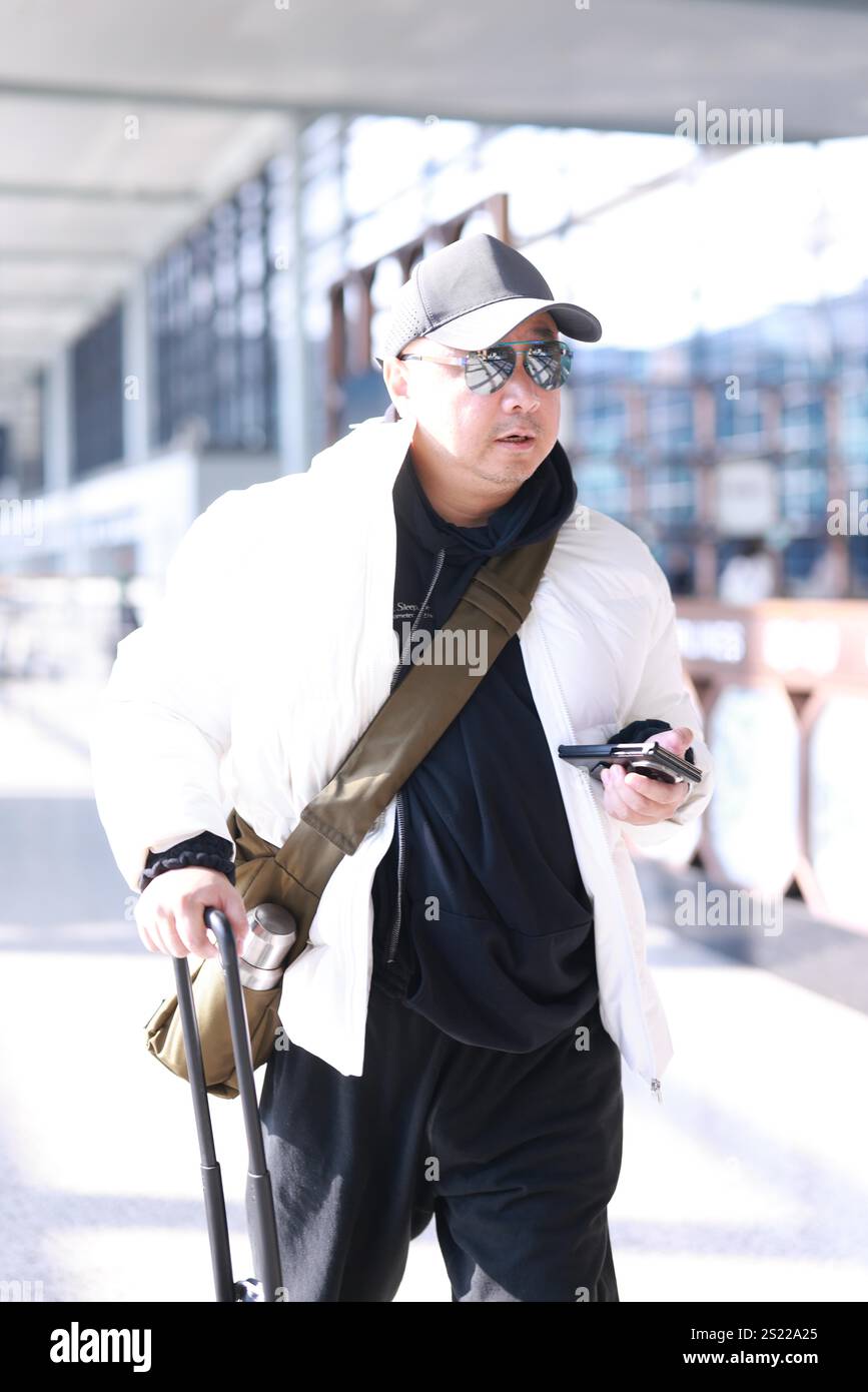 Chinese actor and director Xu Zheng appears at the airport in Shanghai ...