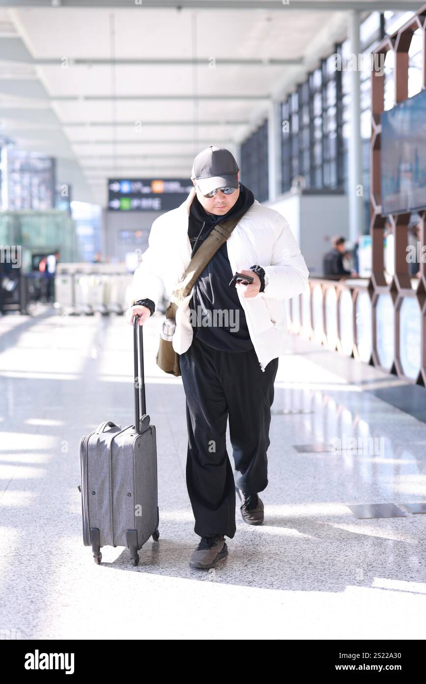 Chinese actor and director Xu Zheng appears at the airport in Shanghai ...