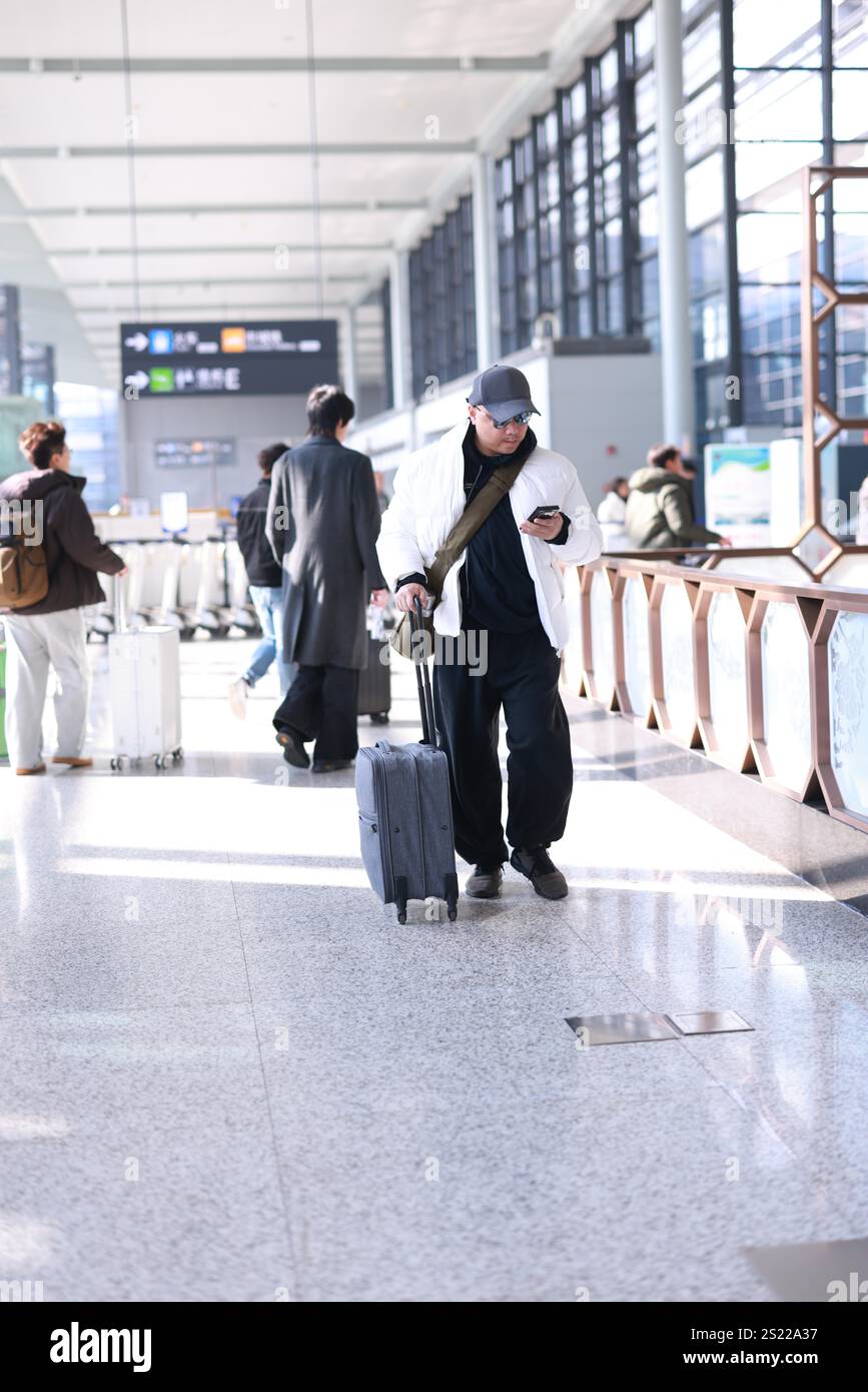 Chinese actor and director Xu Zheng appears at the airport in Shanghai ...