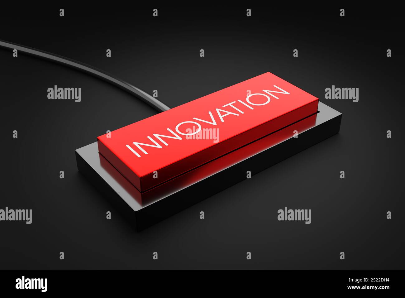 Red innovation button connected to a power cable on a dark background ...