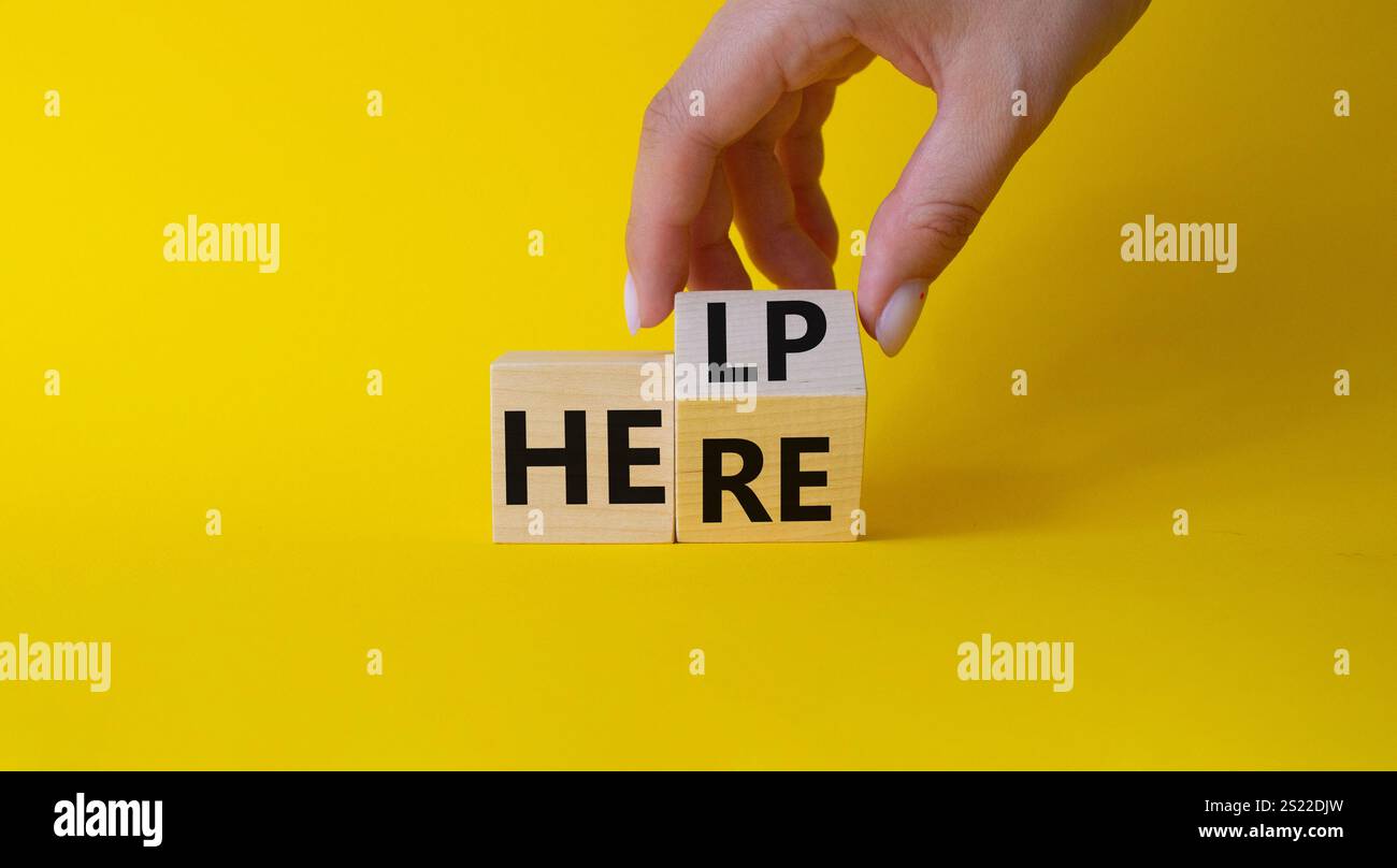 Help is here symbol. Businessman hand Turnes cube and changes word Here ...