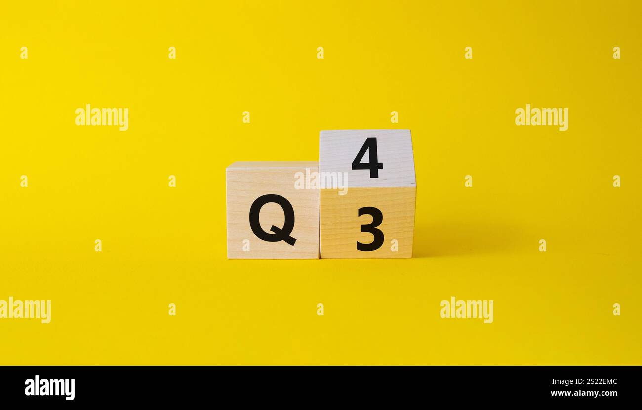 From 3rd Quarter to 4th symbol. Turned wooden cubes with words 3rd ...