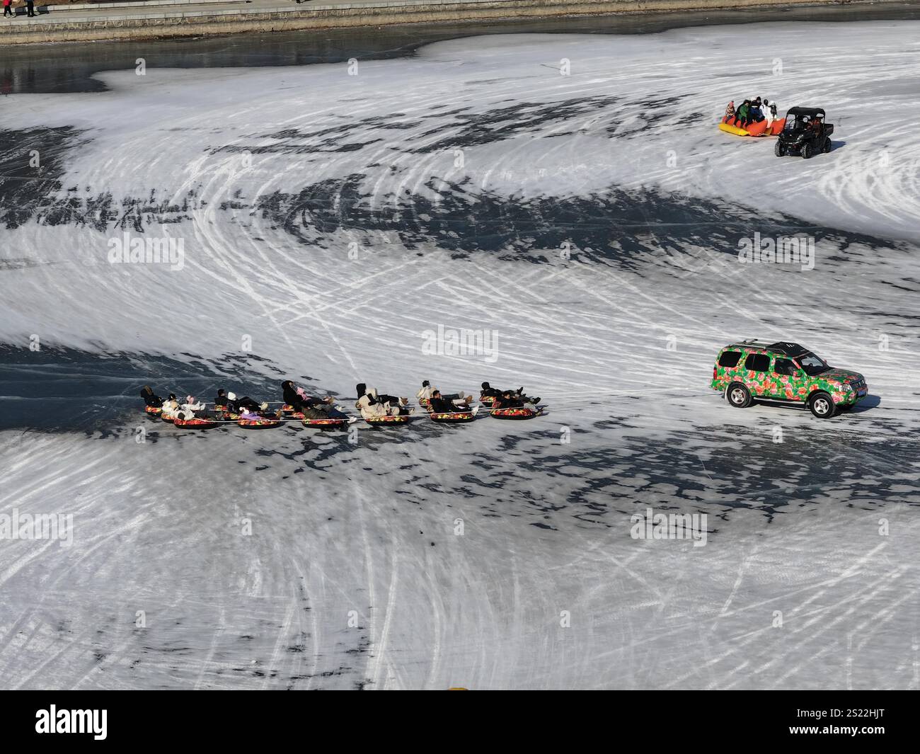 Tourists enjoy winter time at an ice and snow park in Shenyang City ...