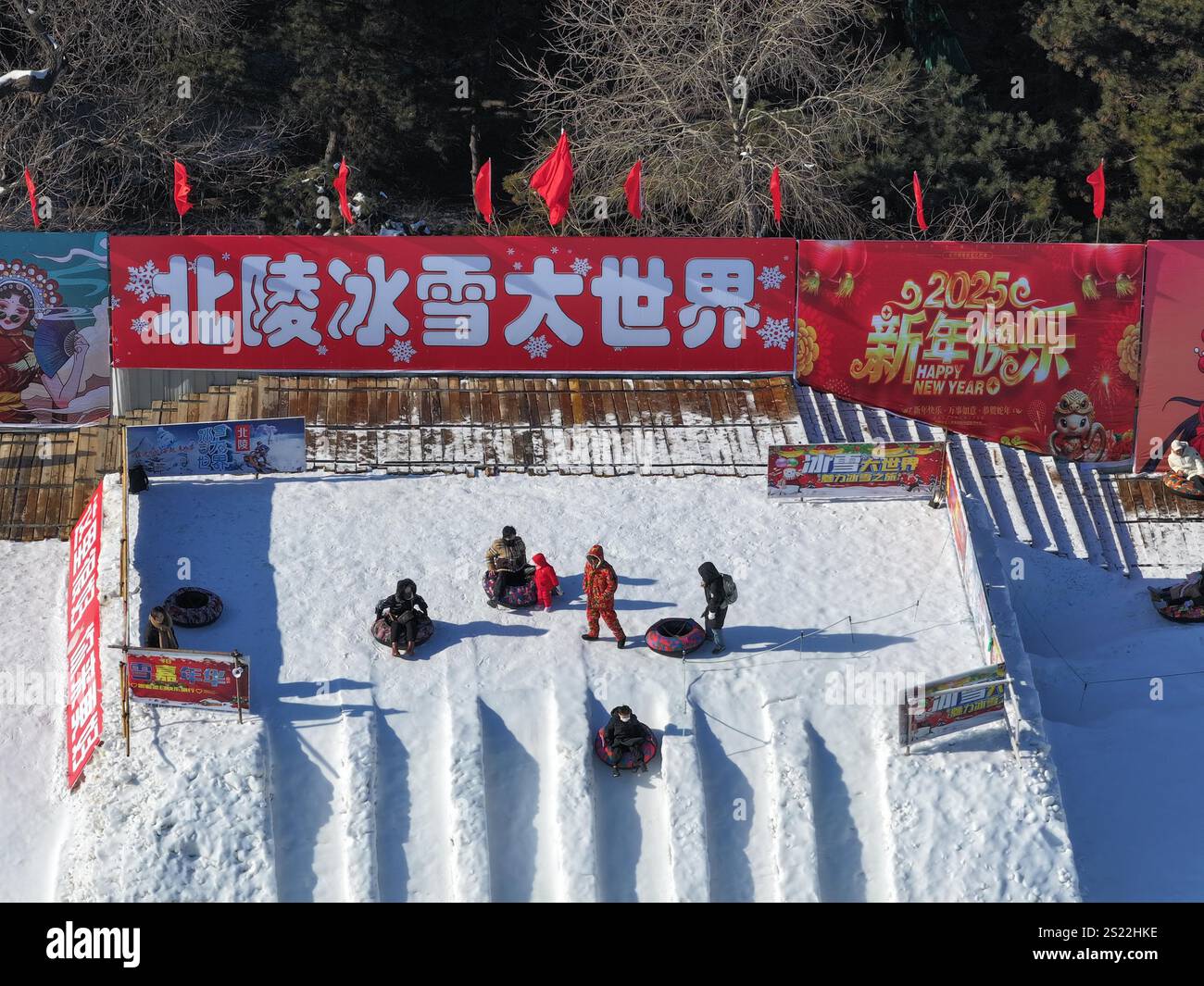 Tourists enjoy winter time at an ice and snow park in Shenyang City ...