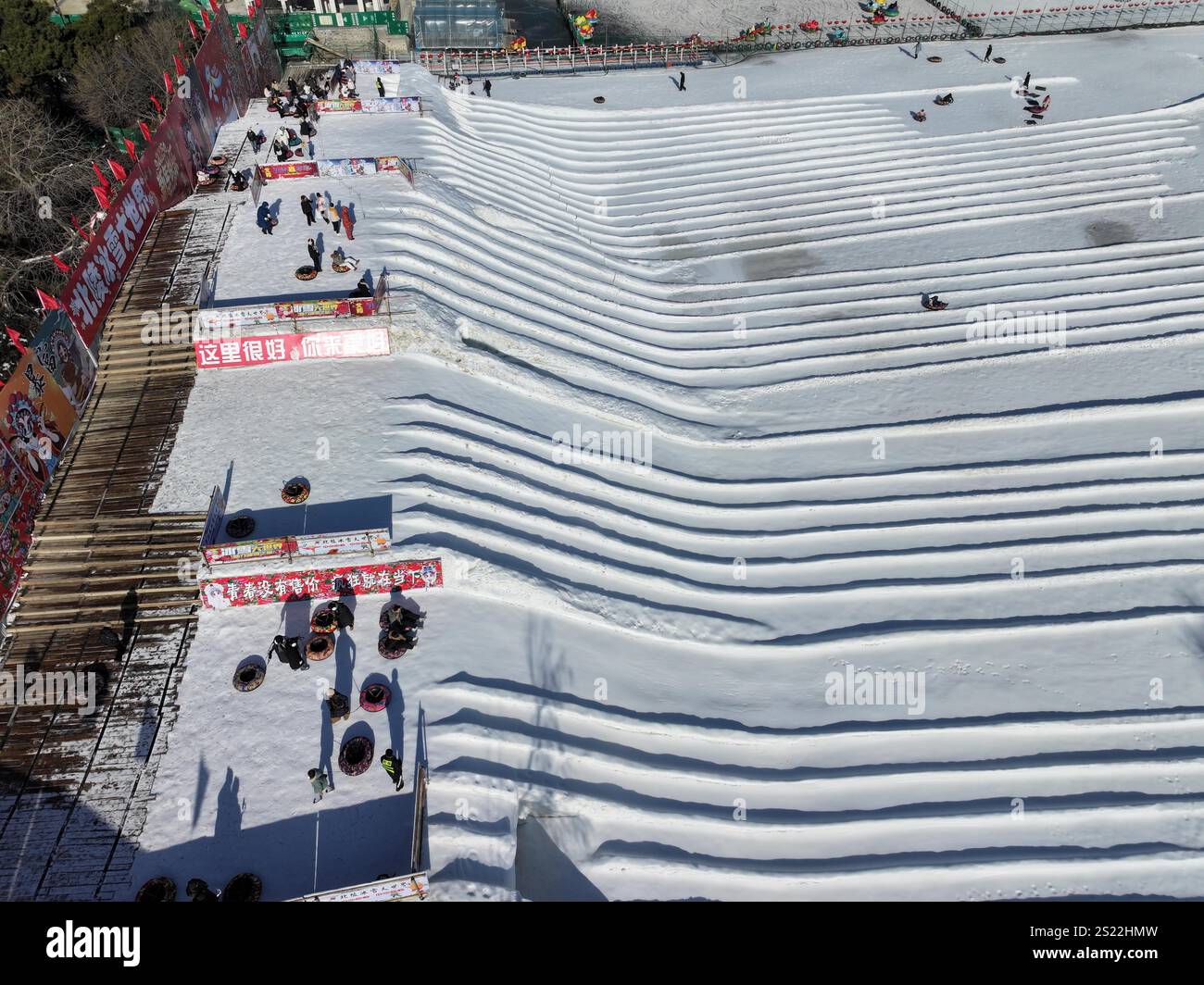 Tourists enjoy winter time at an ice and snow park in Shenyang City ...