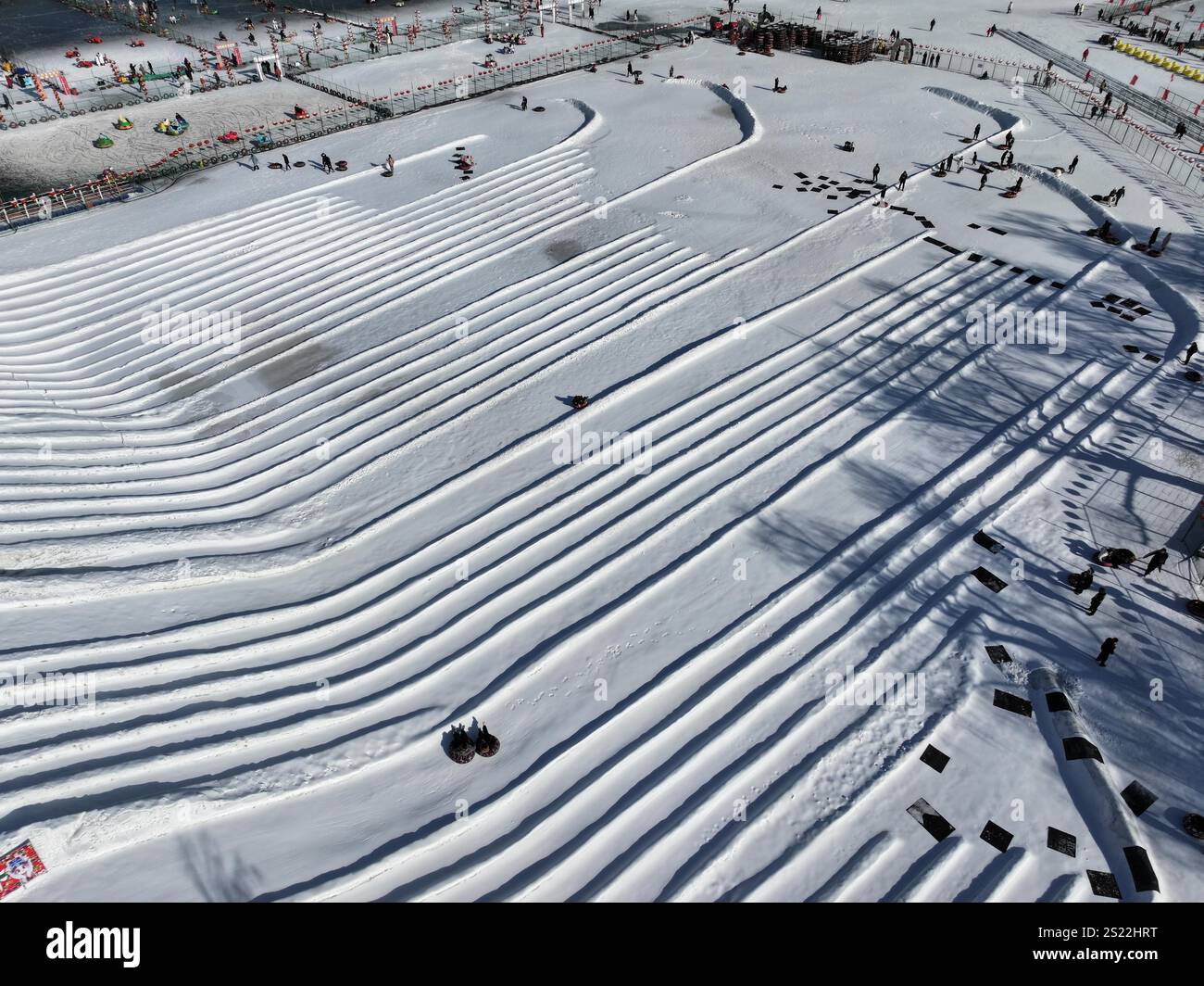 Tourists enjoy winter time at an ice and snow park in Shenyang City ...