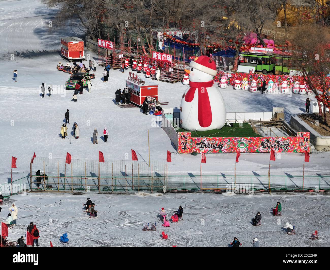 Tourists enjoy winter time at an ice and snow park in Shenyang City ...