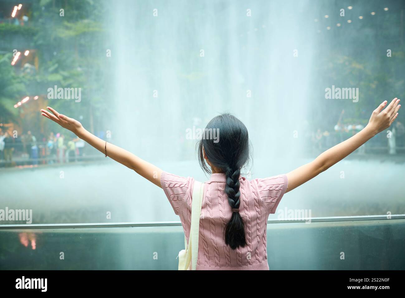 Girl enjoying the mesmerizing view of the hsbc rain vortex at jewel ...