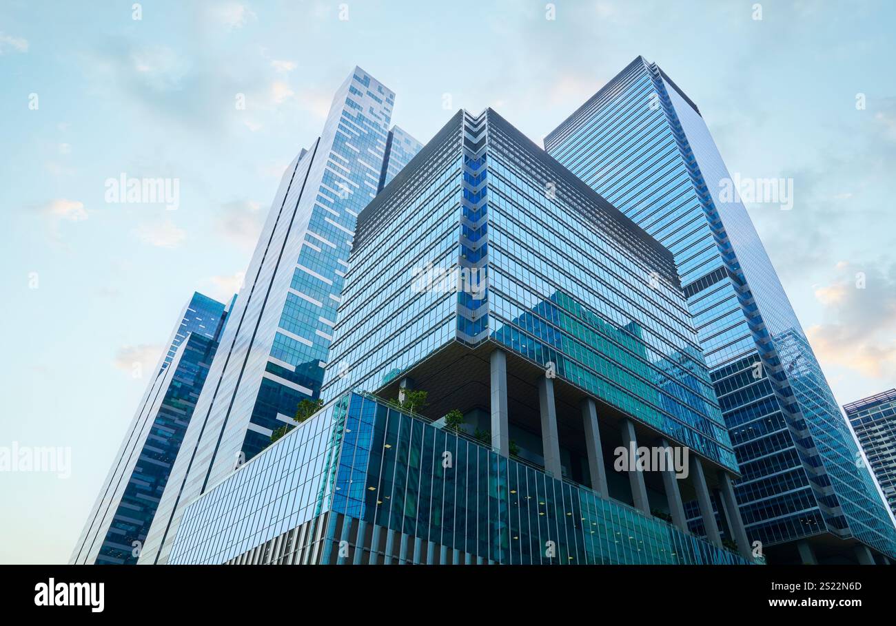 Glass skyscrapers reflecting the blue sky create a powerful image of modern architecture and ...