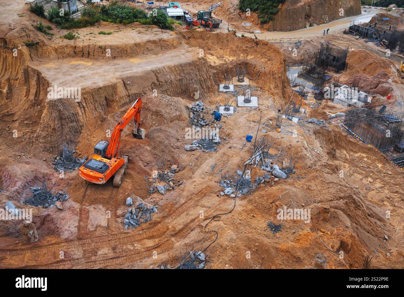 Excavator dig the ground in the foundation pit of a building on a ...