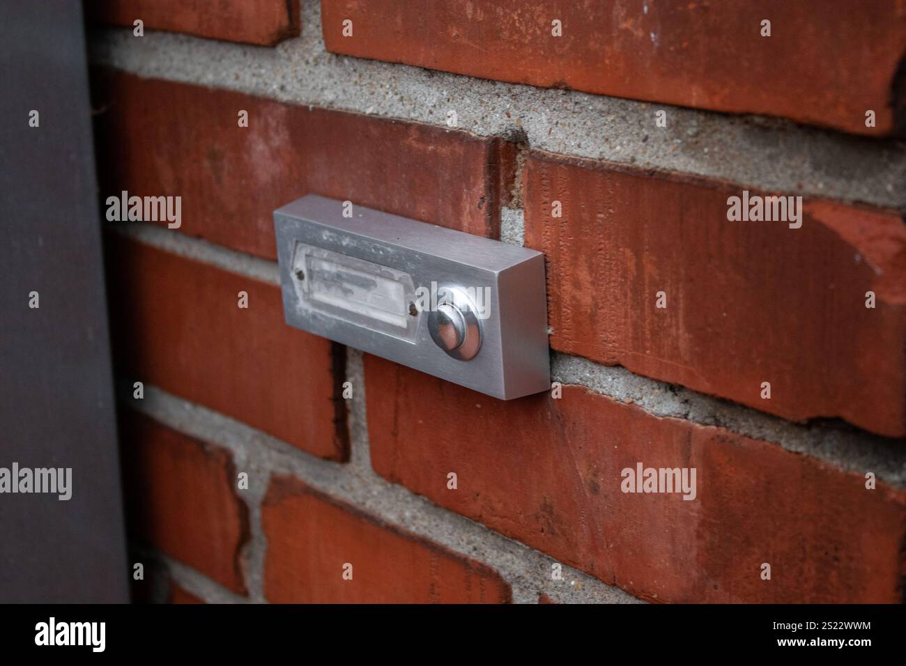 Close up of a simple house doorbell on a bricks wall near the front ...